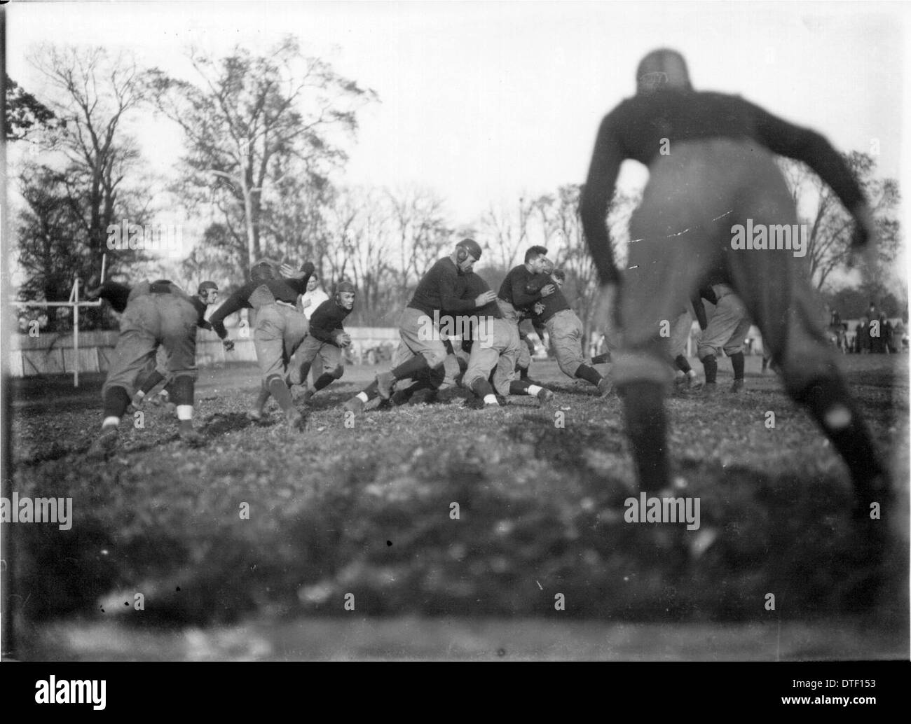 This photograph shows the action at the Miami-Ohio Wesleyan football ...