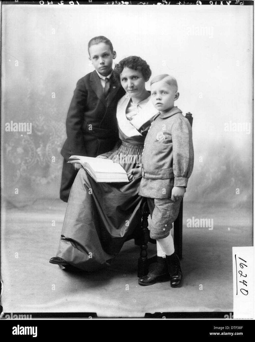This portrait photograph features Mrs. F.W. Nagel with her two sons ...