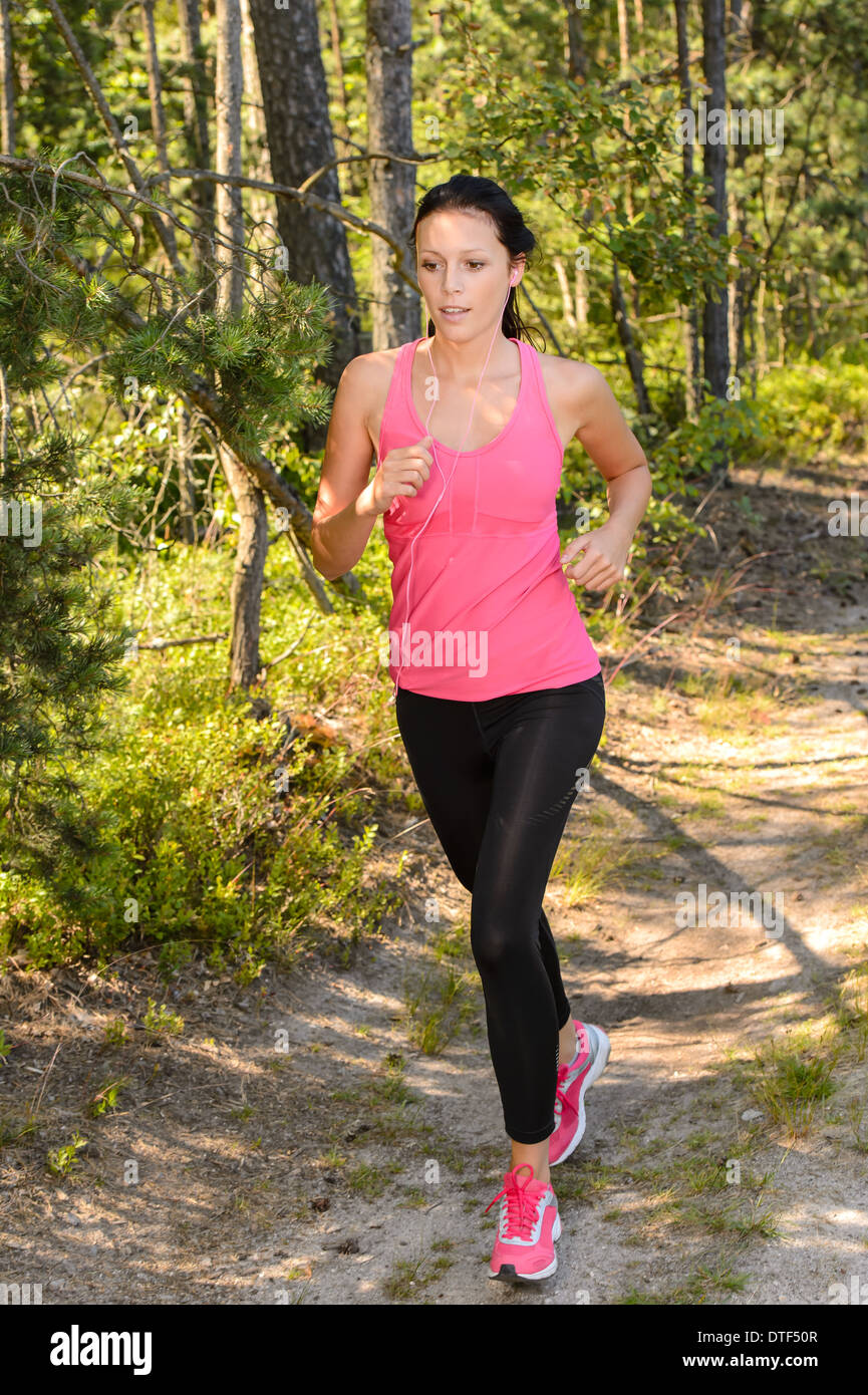 Athlete woman running through forest training in the countryside Stock ...