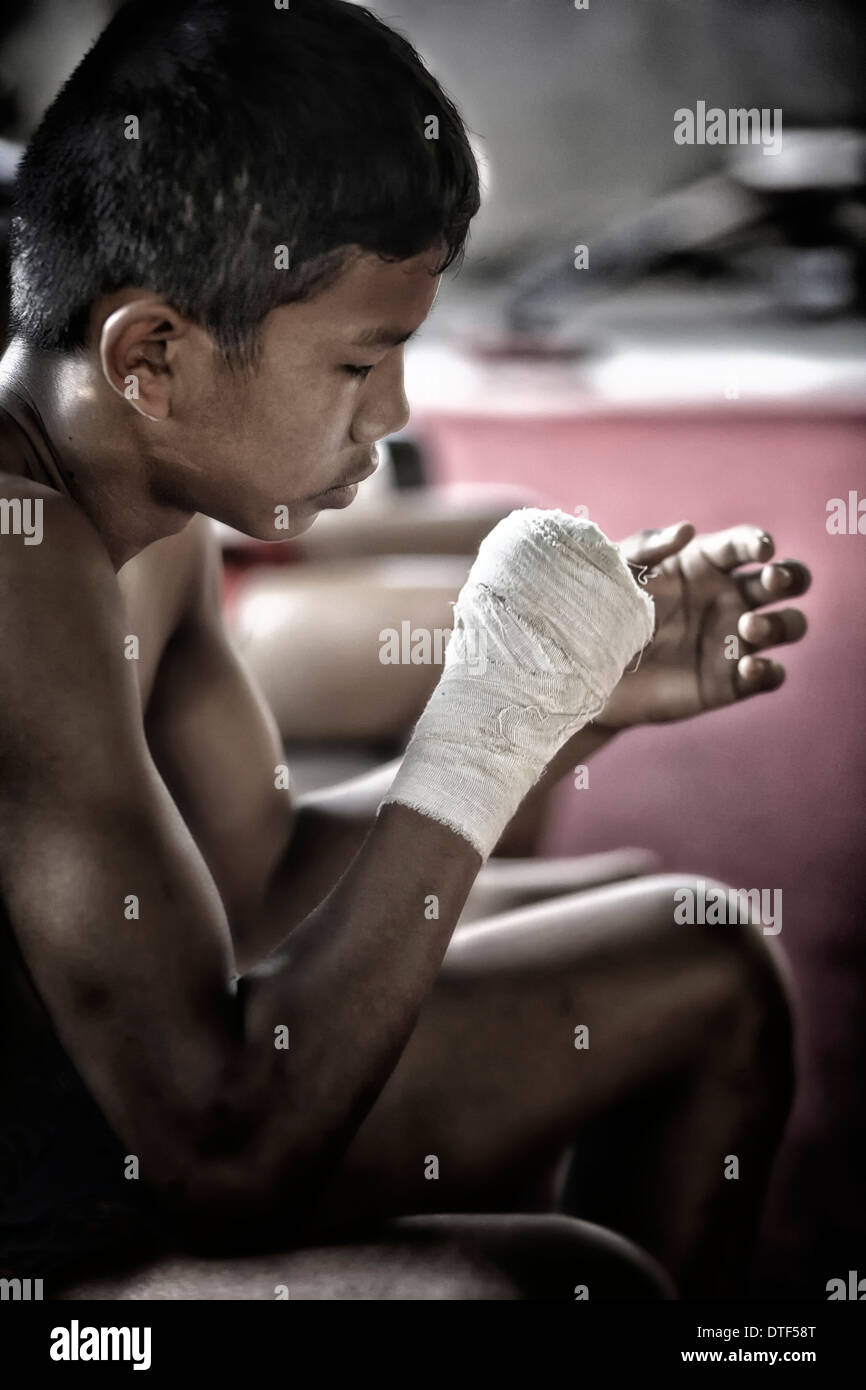 Muay Thai fighter preparing fist hand bandages. Thailand S. E. Asia ...