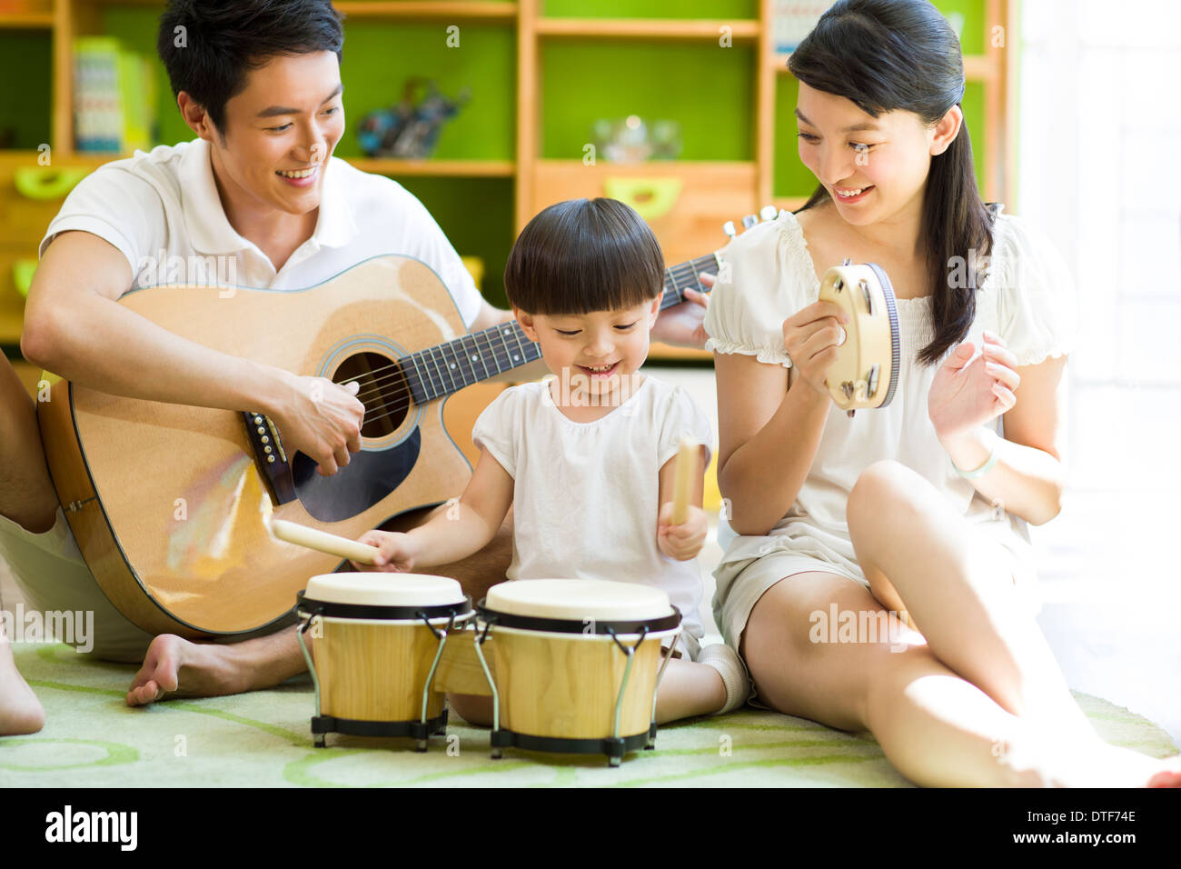 Young family playing musical instruments Stock Photo - Alamy