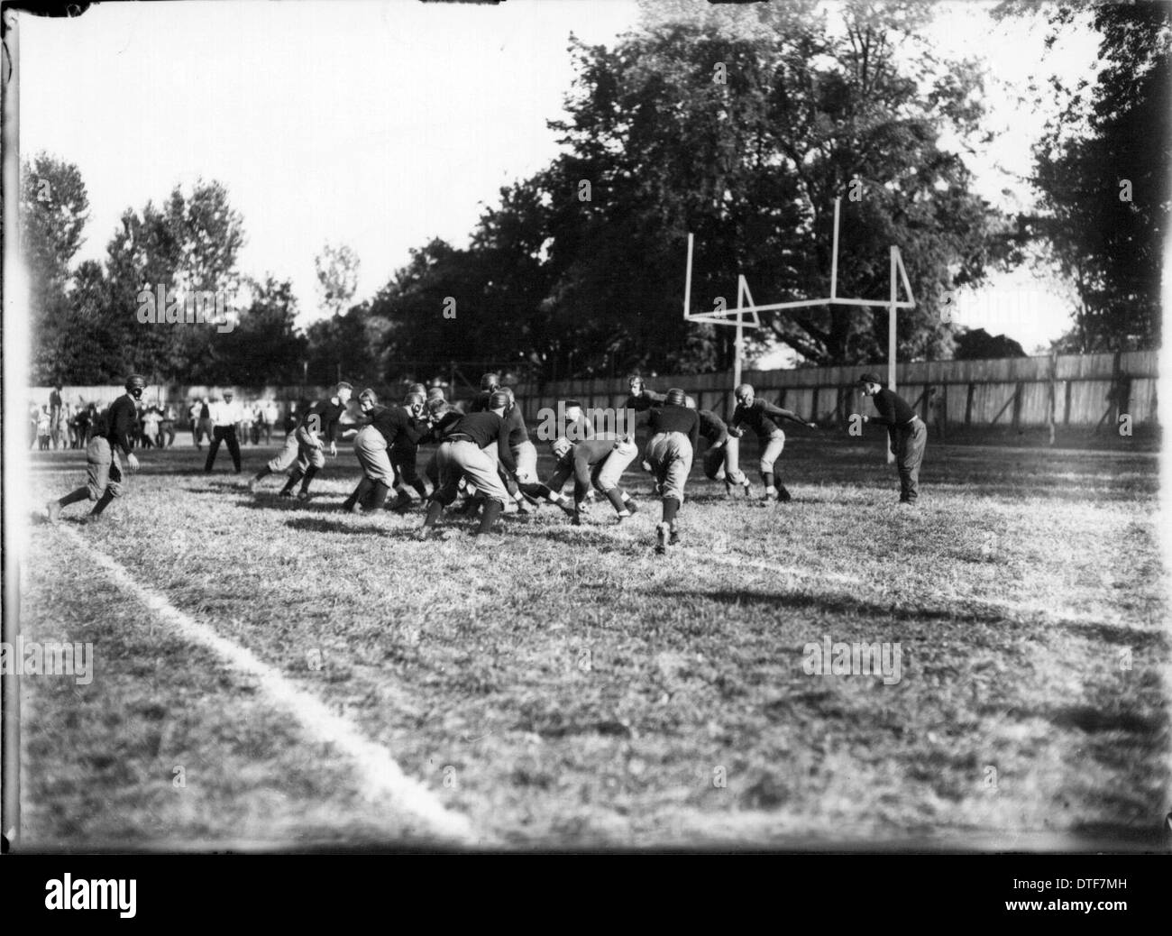 This 1913 photograph captures a key moment of goal line action during a ...