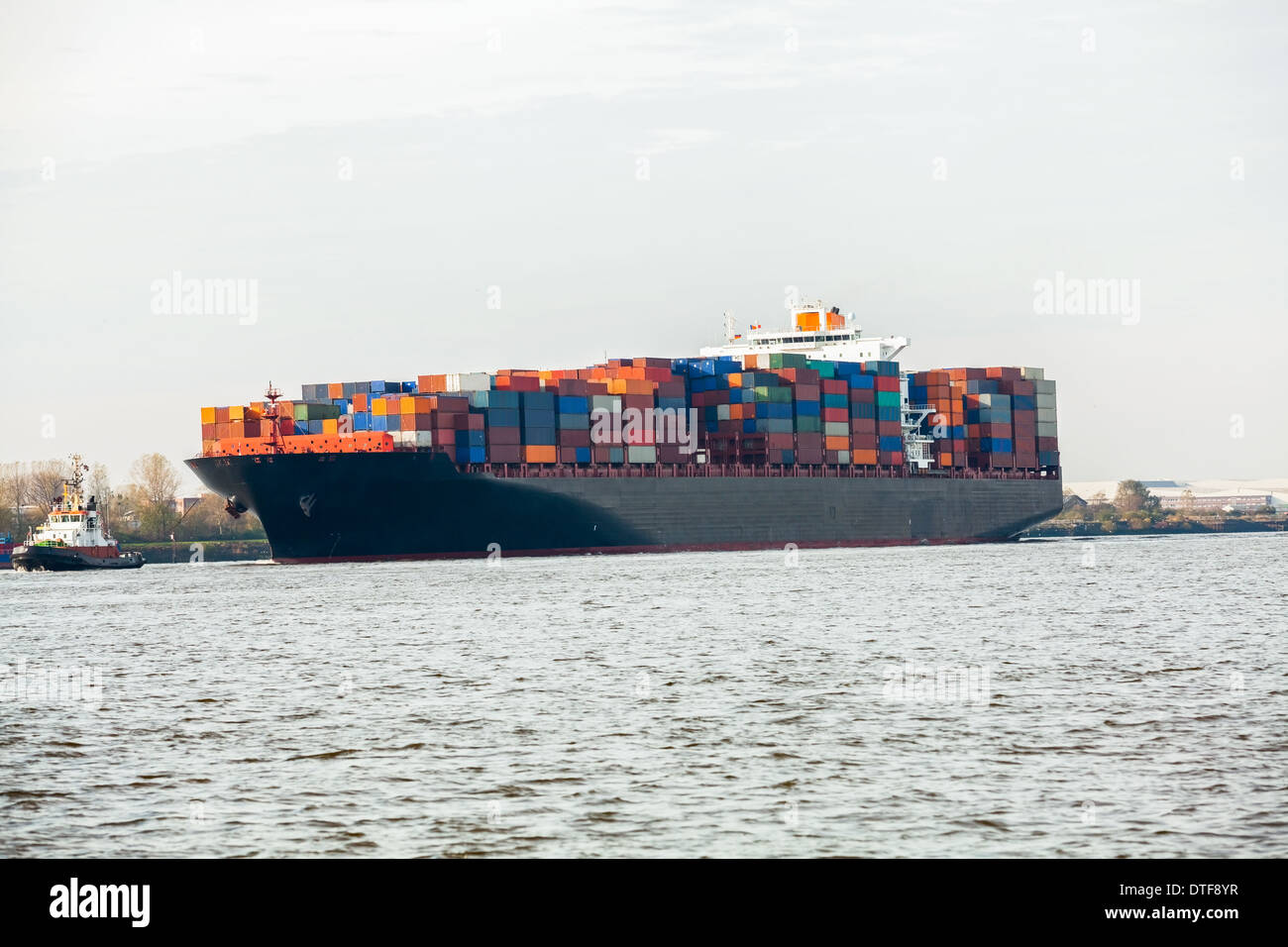 Fully laden container ship in port with its decks stacked with metal ...