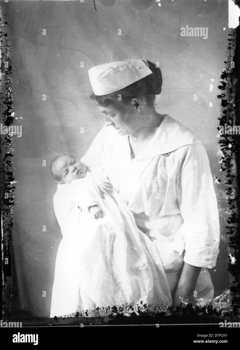 A historic portrait photograph depicting a baby with a nurse, likely ...