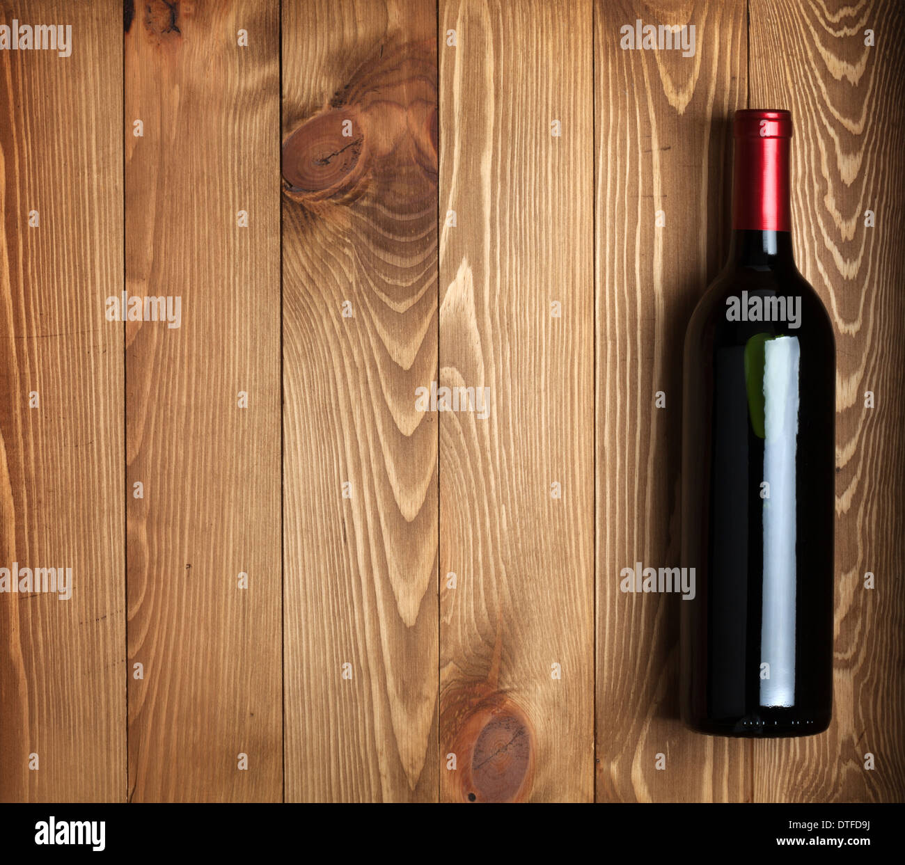 Red wine bottle on wooden table background with copy space Stock Photo ...