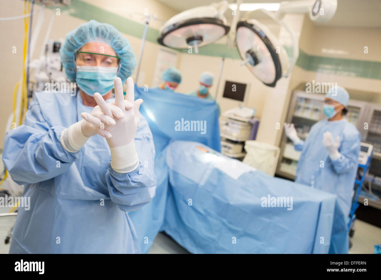 Female Surgeon Adjusting Sterile Gloves Stock Photo - Alamy
