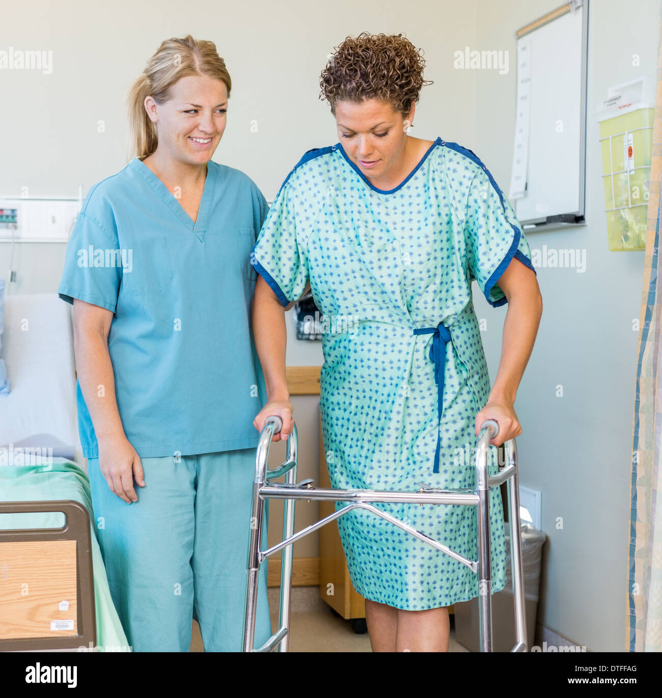 Patient Using Walker While Nurse Looking At Her Stock Photo - Alamy