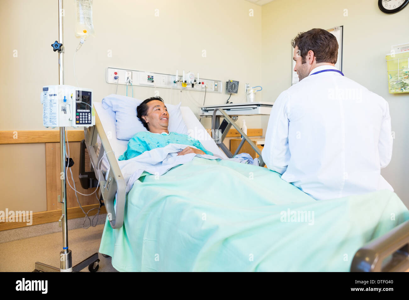 Smiling Patient Looking At Doctor While Lying On Hospital Bed Stock ...
