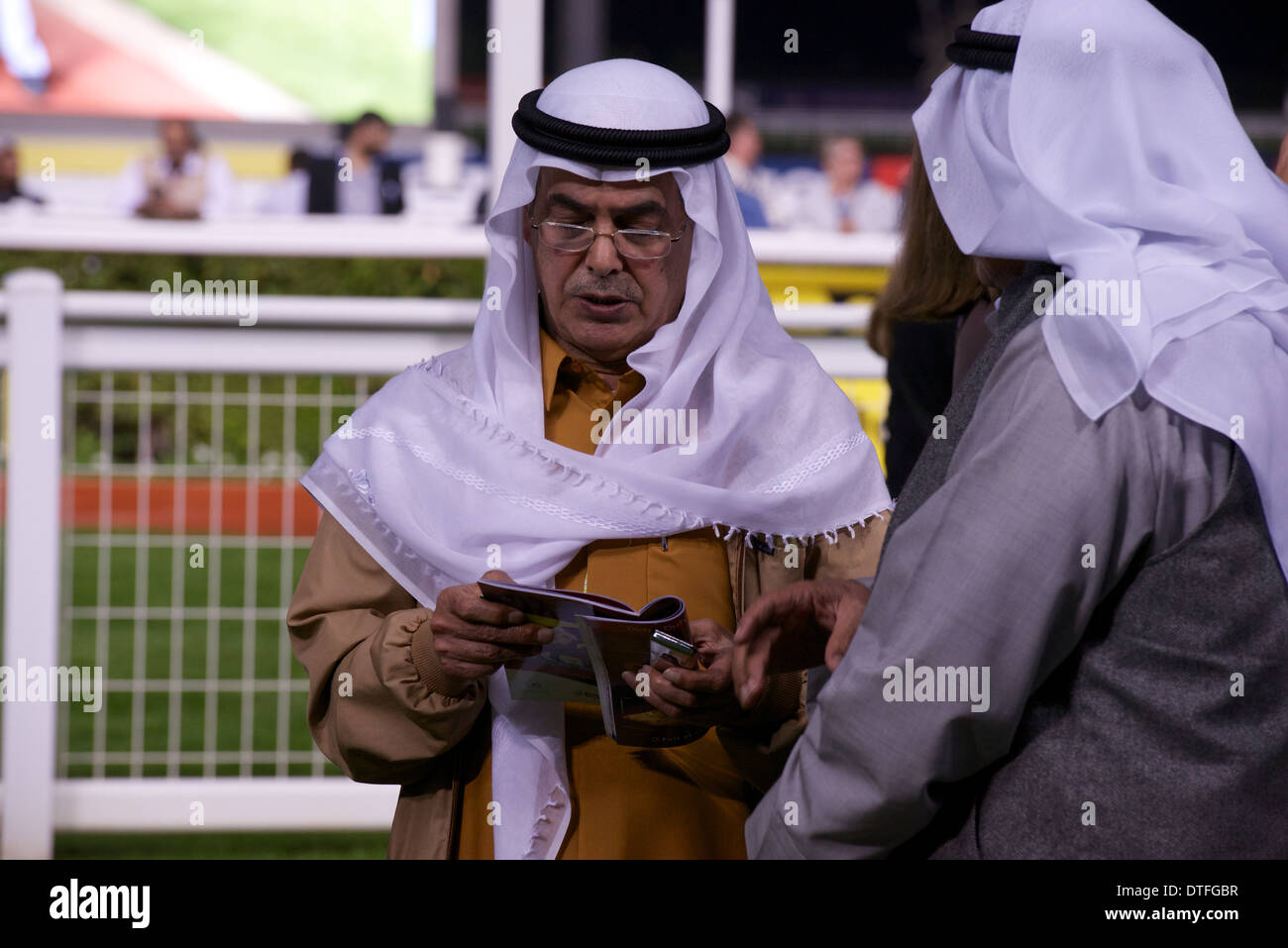 Some of the Emirati owners in the parade ring before the start of race ...