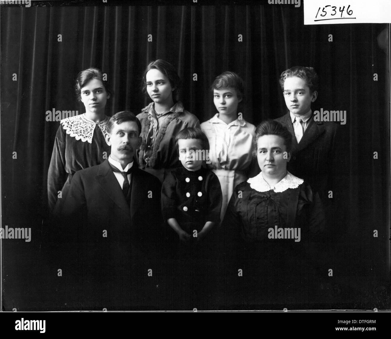This 1916 family portrait by C.H. Newton features a group of family ...
