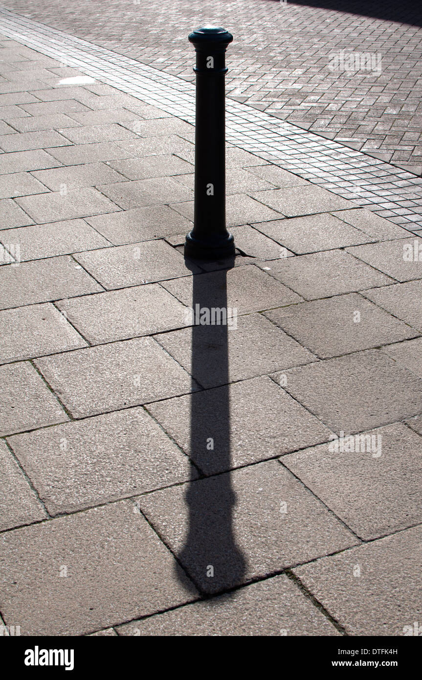 Bollard and shadow Stock Photo - Alamy