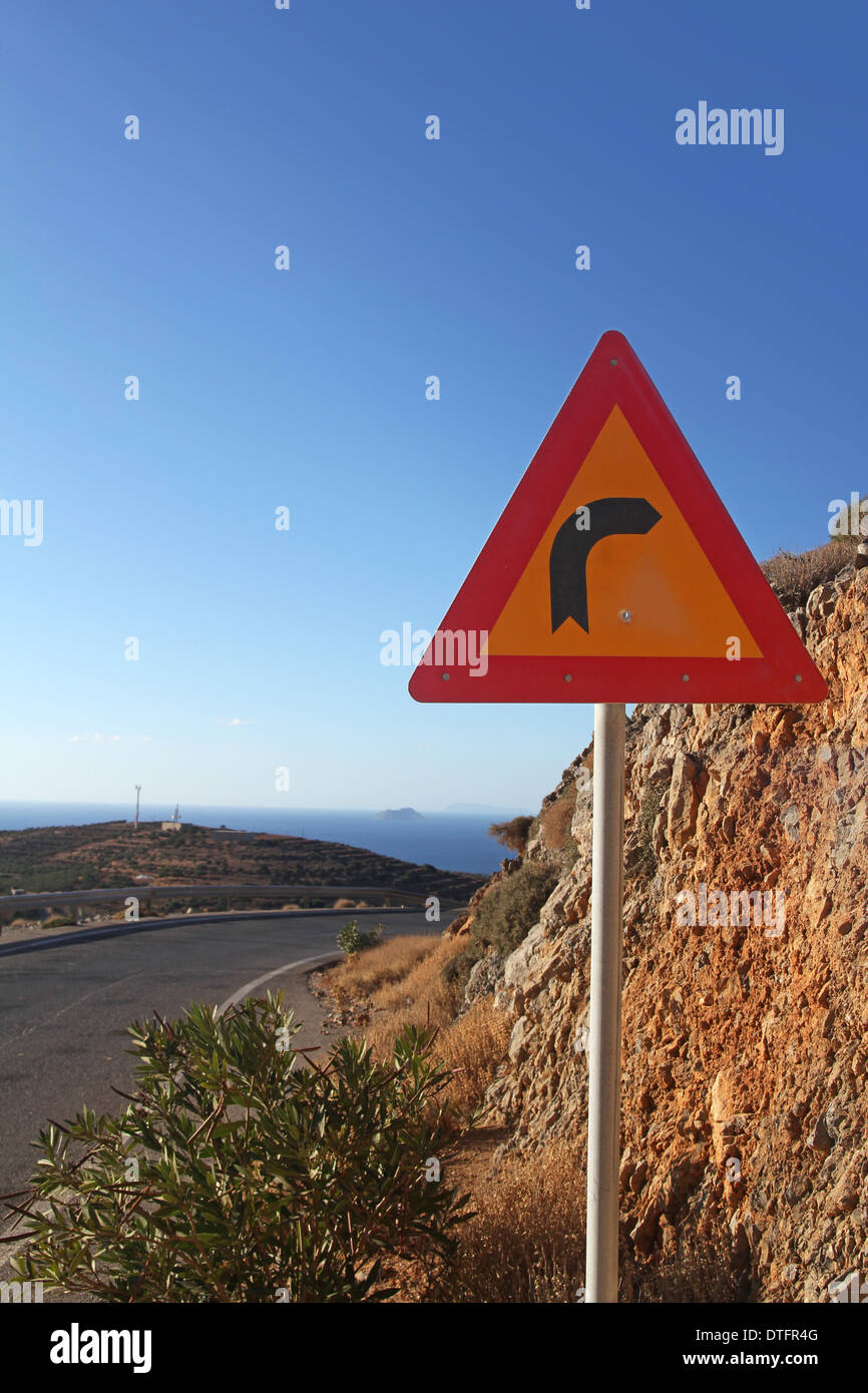 Turn right sign on the mountaing road along the coast - Crete, Greece ...
