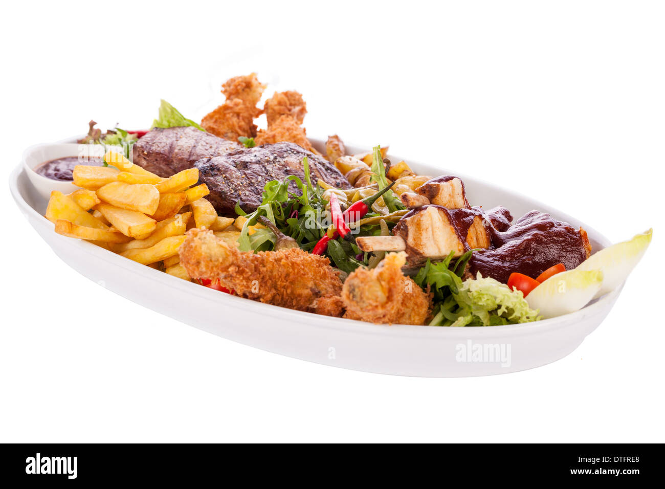 Wholesome platter of mixed meats including grilled steak, crispy ...