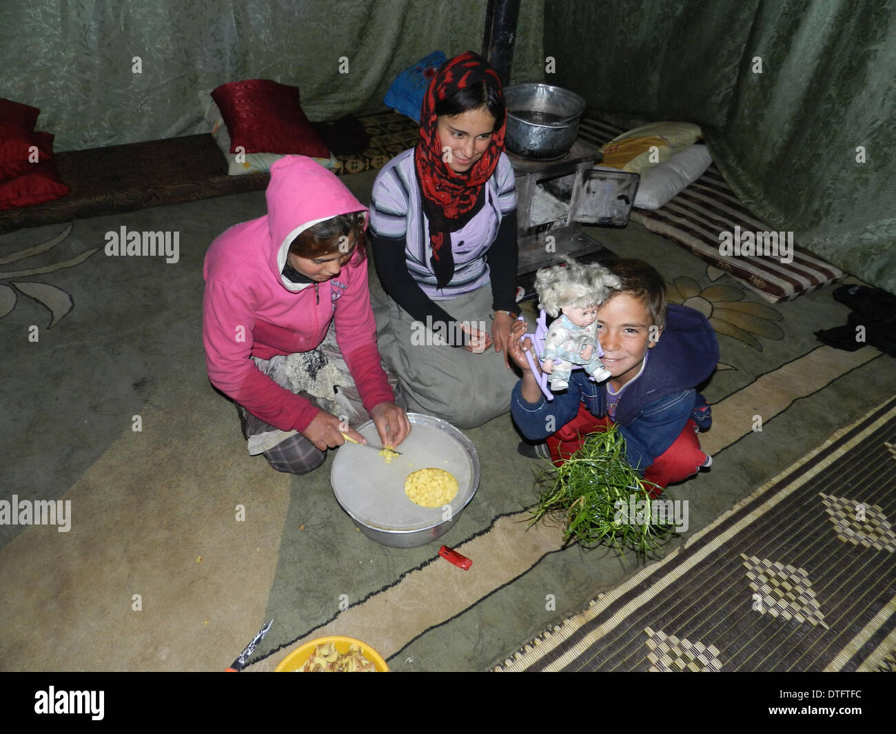 Beirut. 14th Feb, 2014. Syrian refugees cook inside a makeshift tent in ...