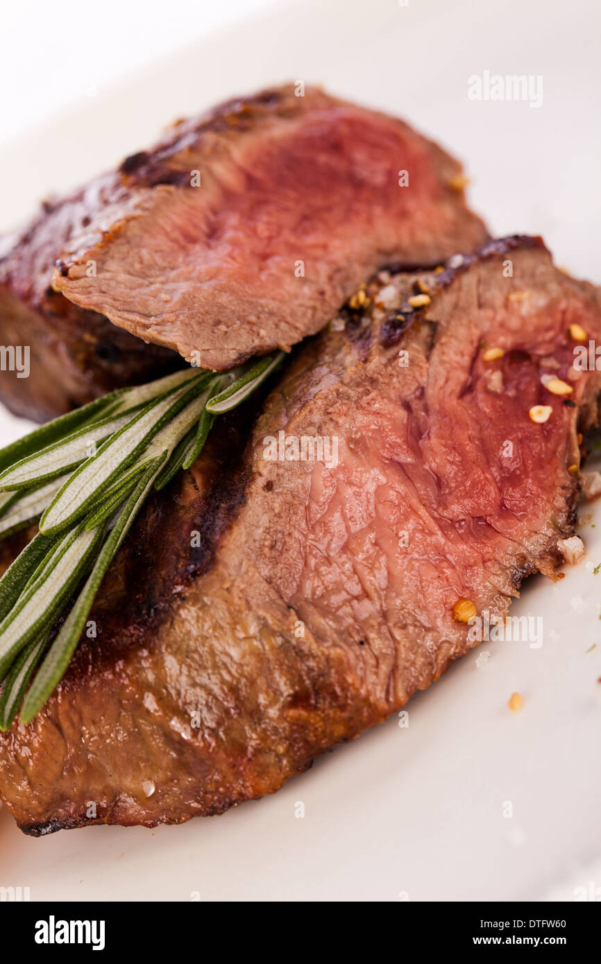 Succulent medium rare beef steak sliced through to display the tender ...