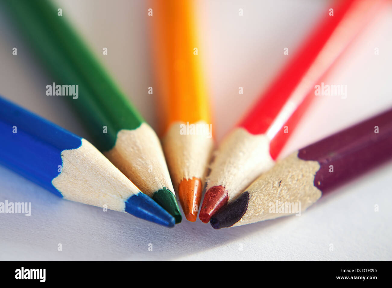 Crayons on paper board with tips together Stock Photo - Alamy