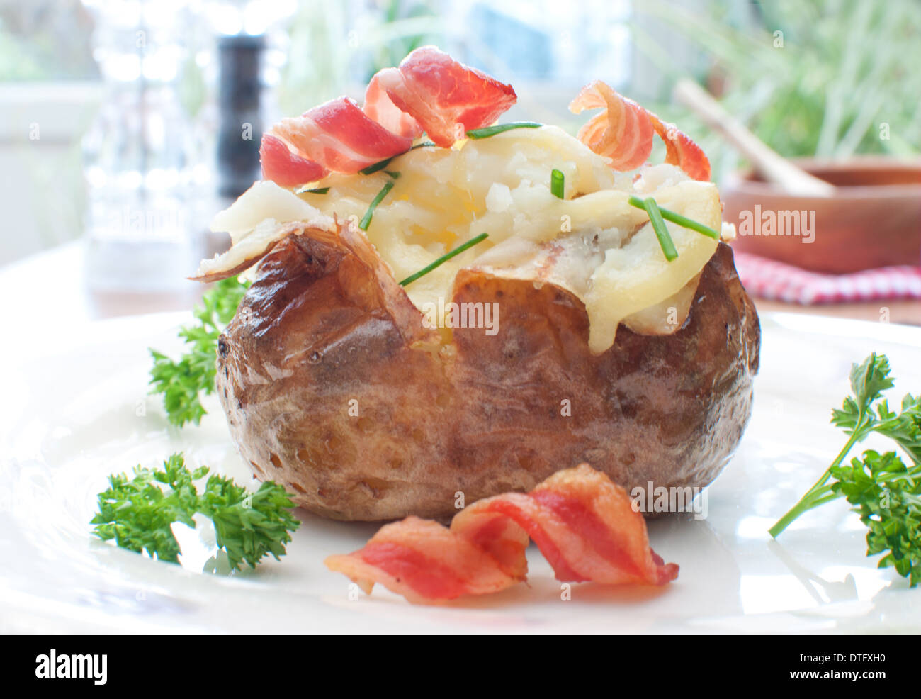 Baked jacket potato with bacon and chives Stock Photo - Alamy