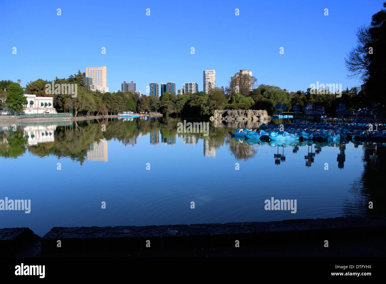 Reflection of Polanco buildings in the lake in Chapultepec Park, Mexico ...