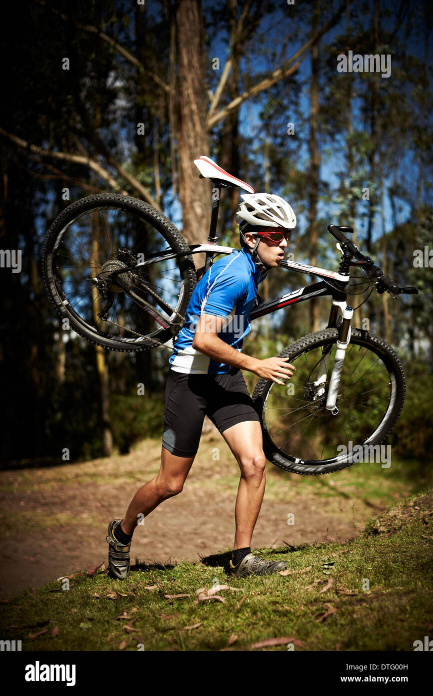 Young man running with a bike Stock Photo - Alamy