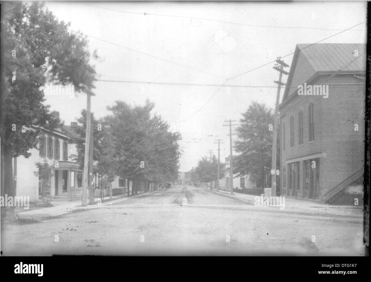 This image shows a residential area with trolley tracks running through ...