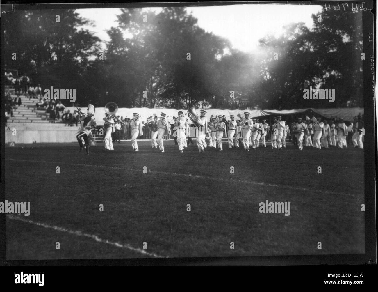 The photograph captures a marching band performing on the field during ...