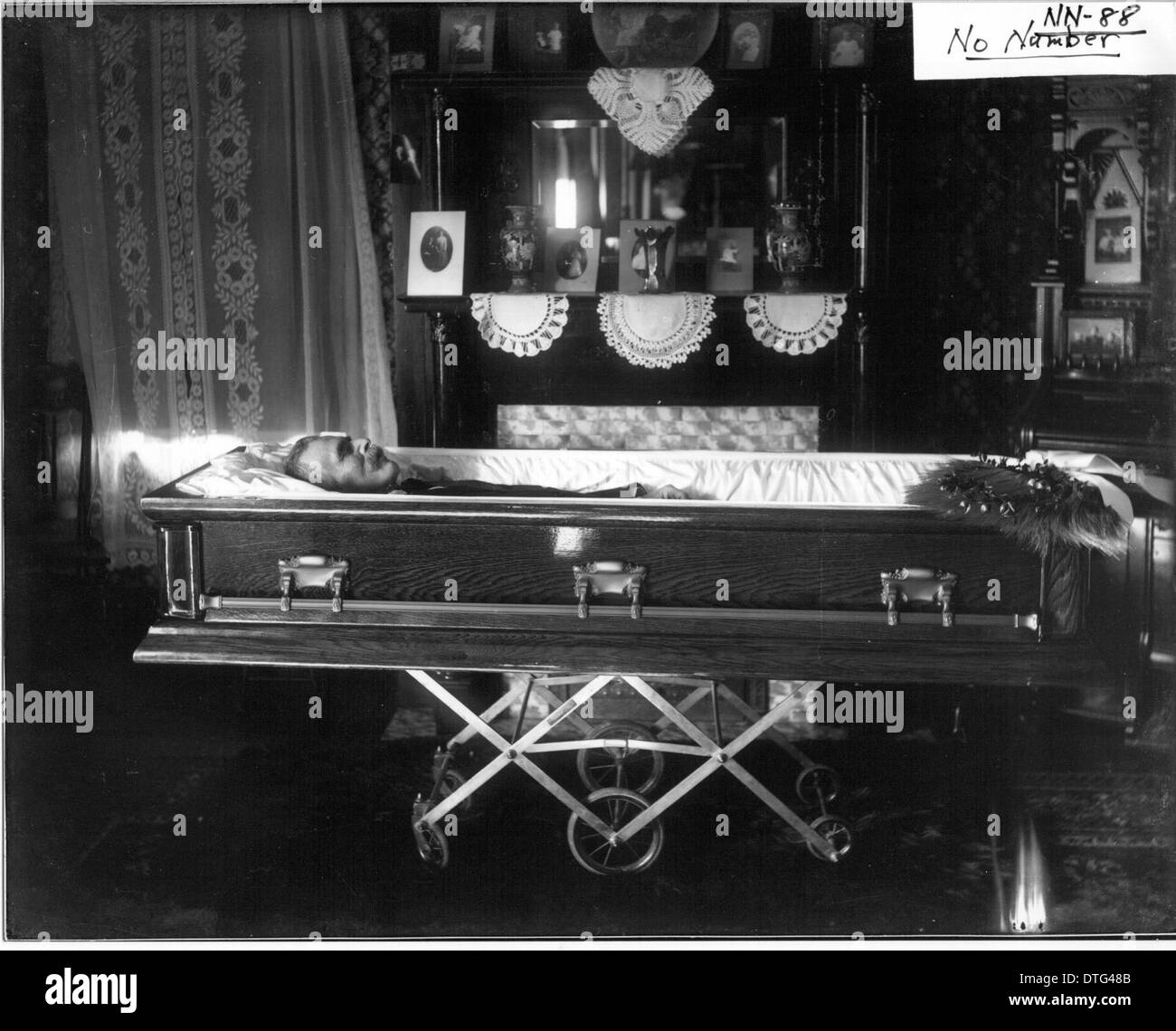 This photograph, showing an unidentified man in a casket, reflects the ...