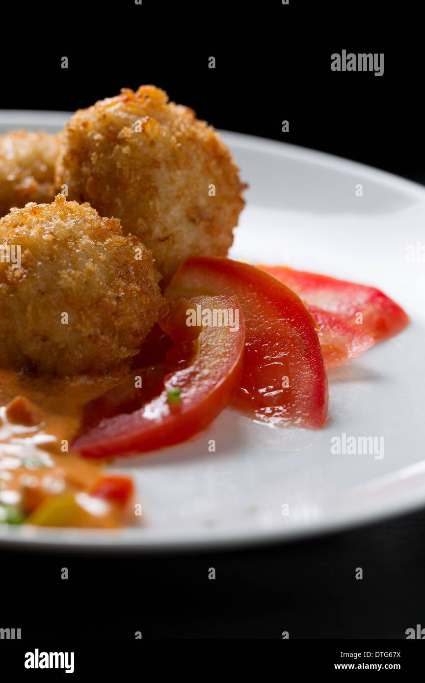 Dish of fried rice balls coated with breadcrumbs, Arancini, with tomato ...