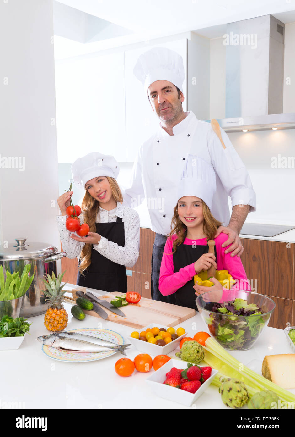 Chef master and junior pupil kid girls at cooking school with food on ...