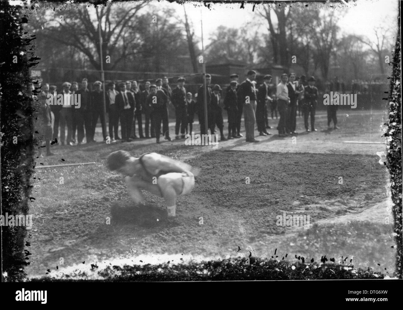 This photograph captures a high-jumping event at a track meet ...