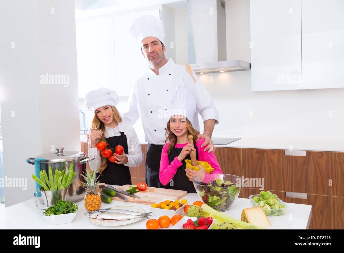 Chef master and junior pupil kid girls at cooking school with food on ...