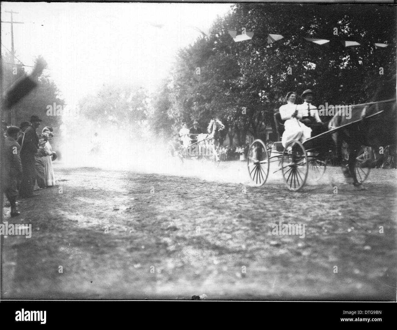 This early 20th-century photograph captures a buggy race or procession ...