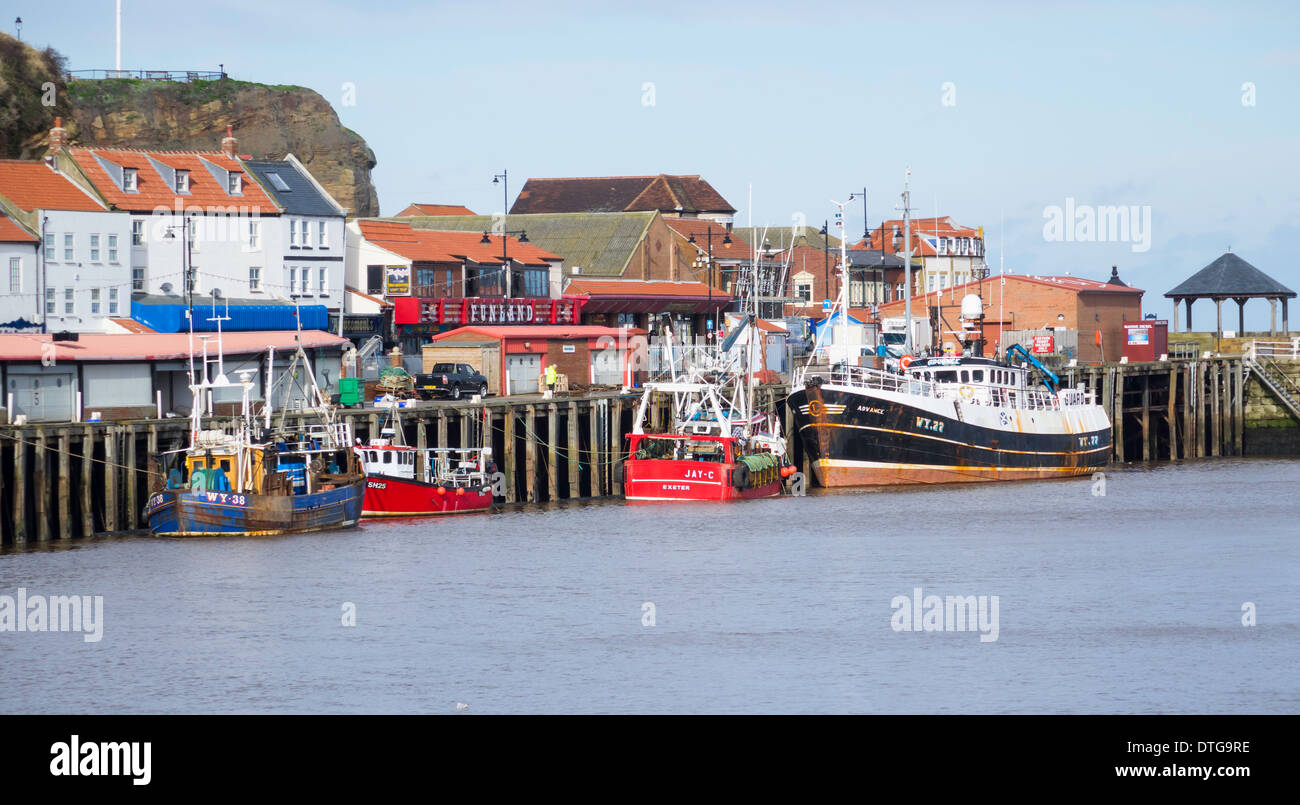 Black blue and red fishing boats tied up at the fish quay Whitby, North ...