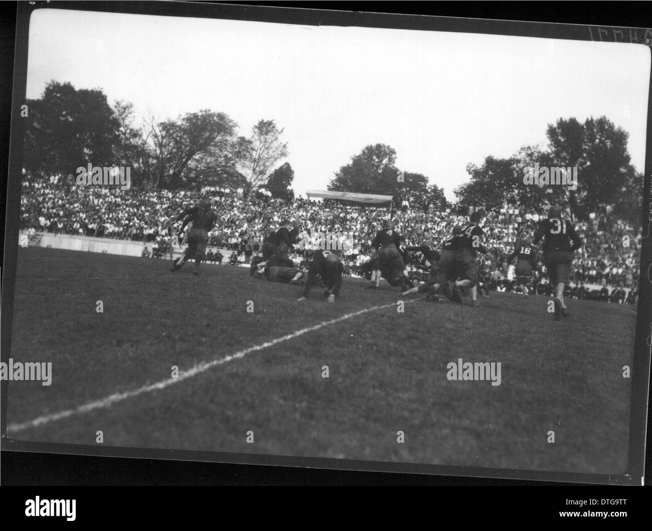 A historic photograph capturing the action at a 1926 football game ...