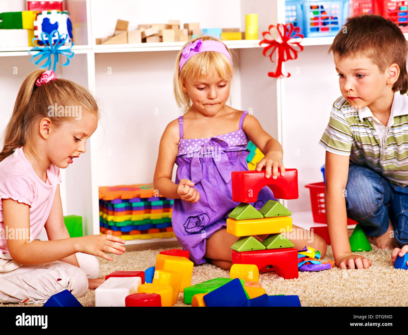 Children in kindergarten stacking block Stock Photo - Alamy