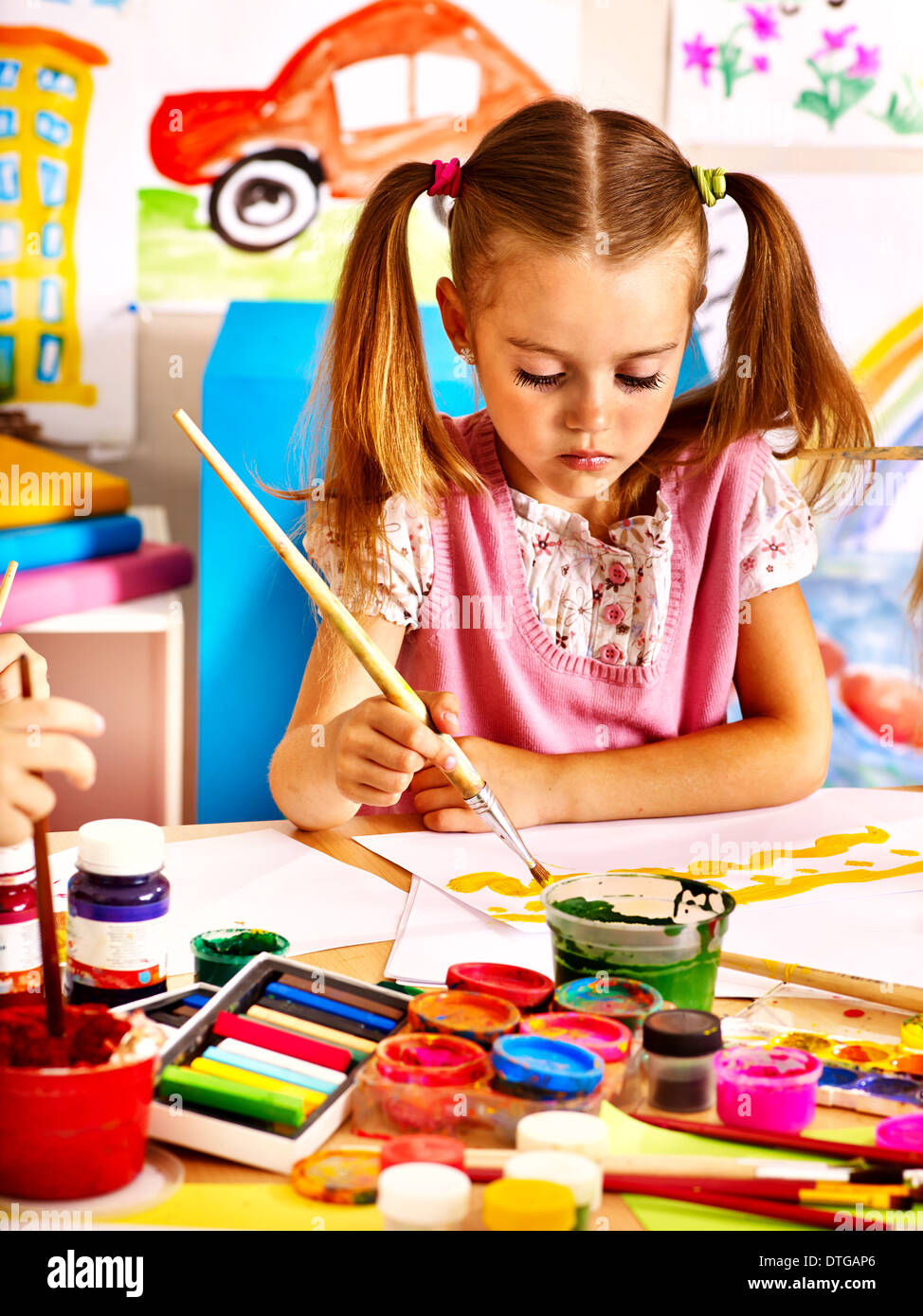 Child painting at easel in school Stock Photo - Alamy