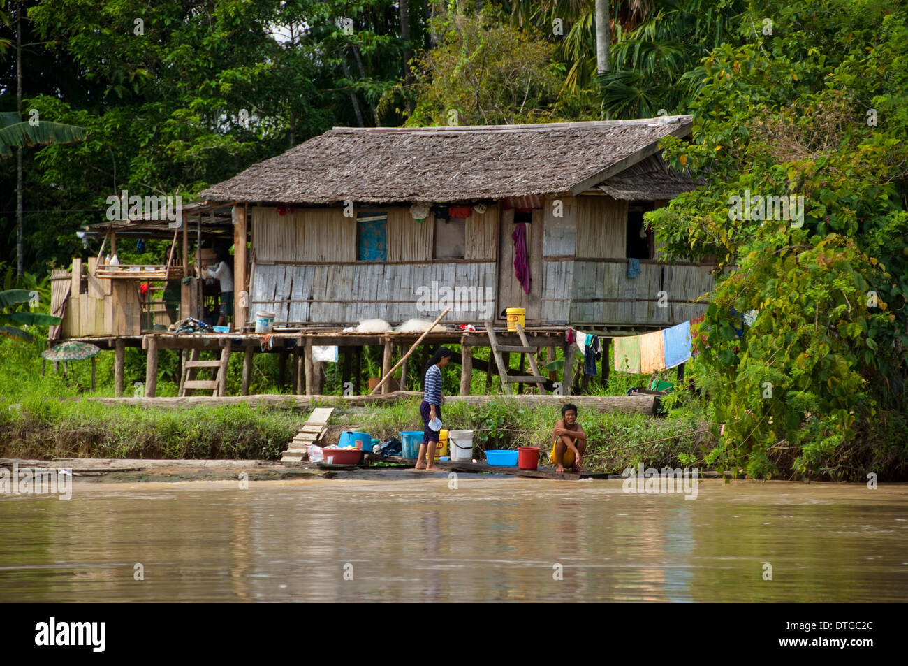 Villagers doing laundry on riverbank, Kinabatangan River, Sabah ...