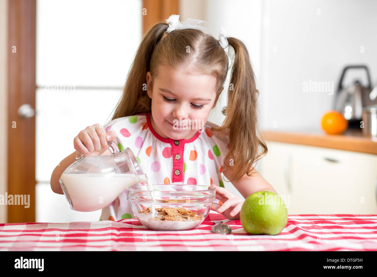kid girl preparing corn flakes with milk Stock Photo - Alamy