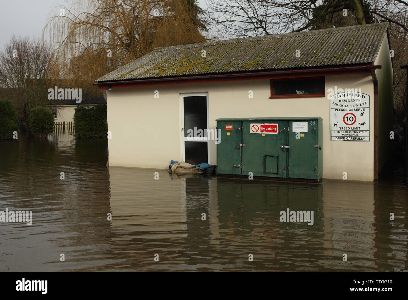 Ham Island, Thames Valley, UK Flood waters surround electricity box ...