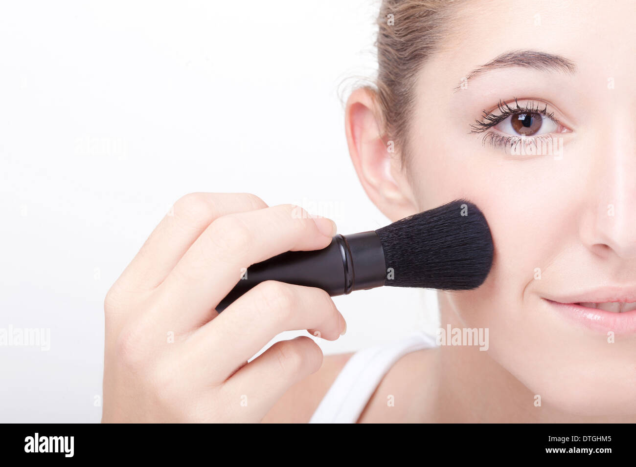 teenage girl applying blush Stock Photo - Alamy