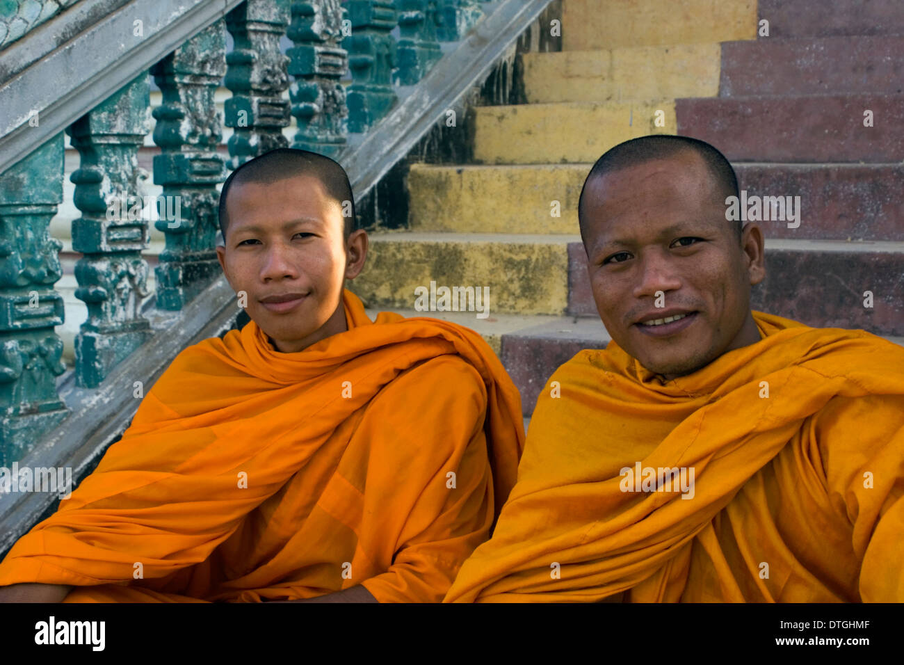 Two Buddhist monks wearing orange safron robes are enjoying their day ...