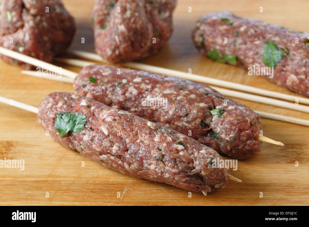 Making lamb kofta barbecue skewers on a wooden board Stock Photo - Alamy
