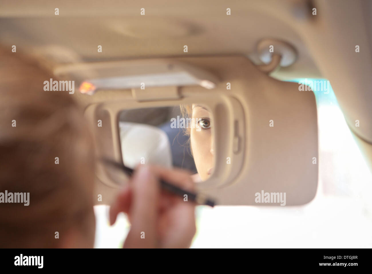 woman looking in the mirror of a car Stock Photo - Alamy