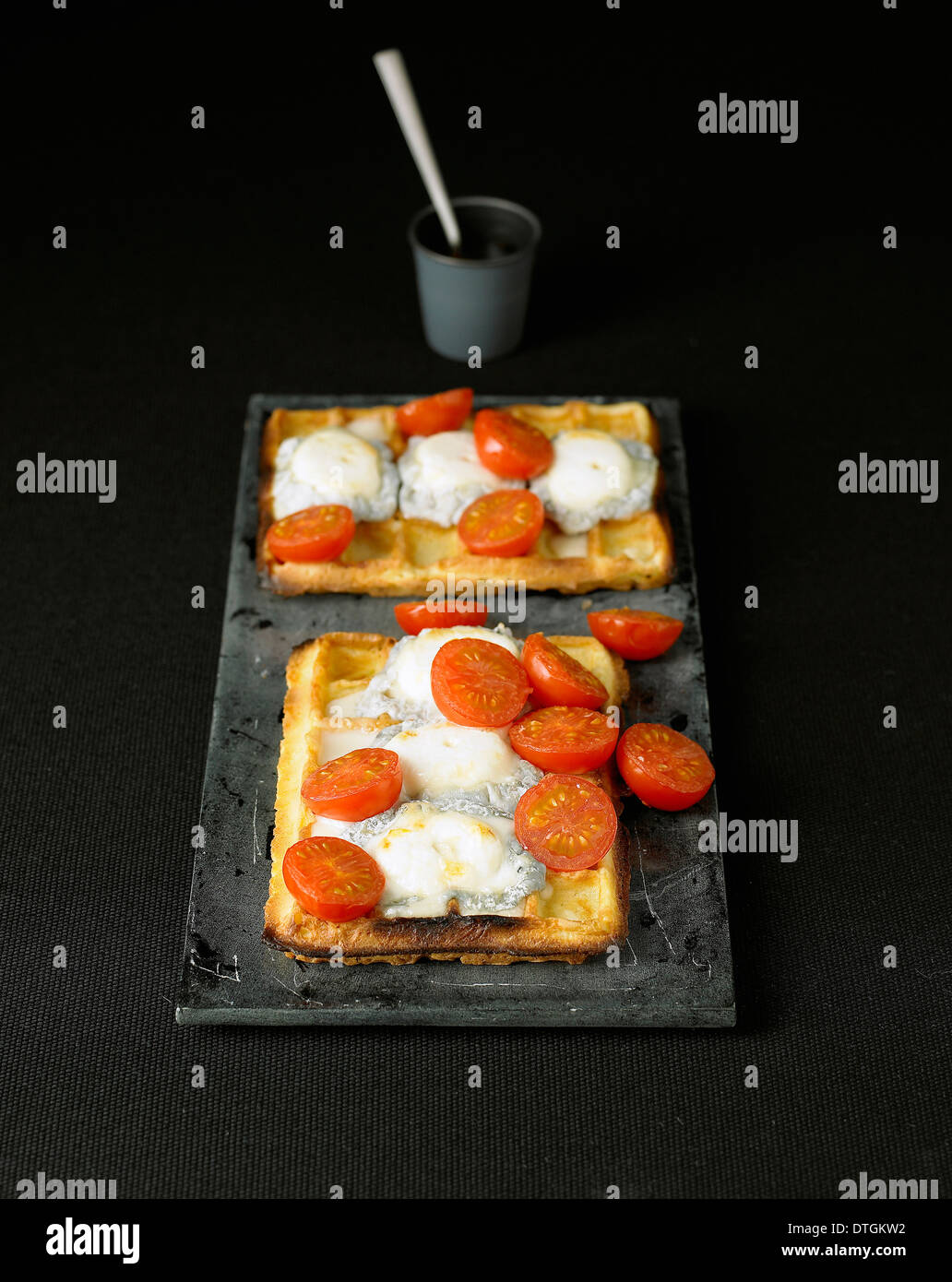 Waffles with goat's cheese and cherry tomatoes Stock Photo - Alamy