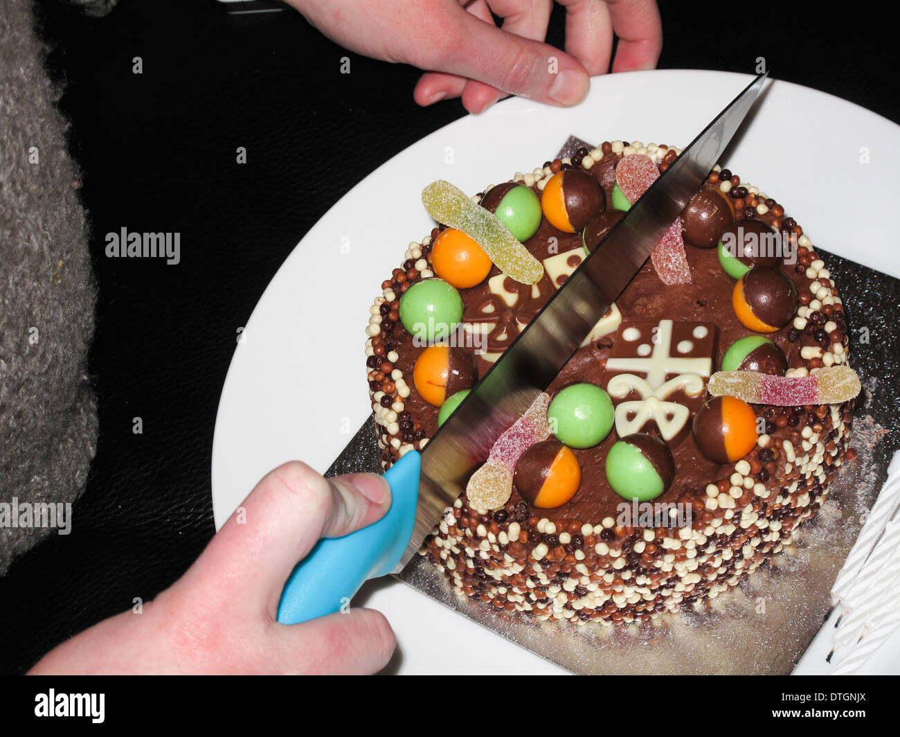 Cutting home made chocolate cake Stock Photo - Alamy