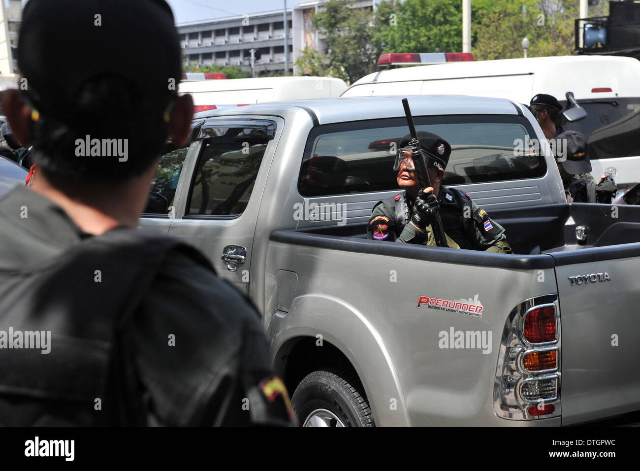 Bangkok, Thailand. 18th Feb, 2014. A Thai riot police officer holds a ...