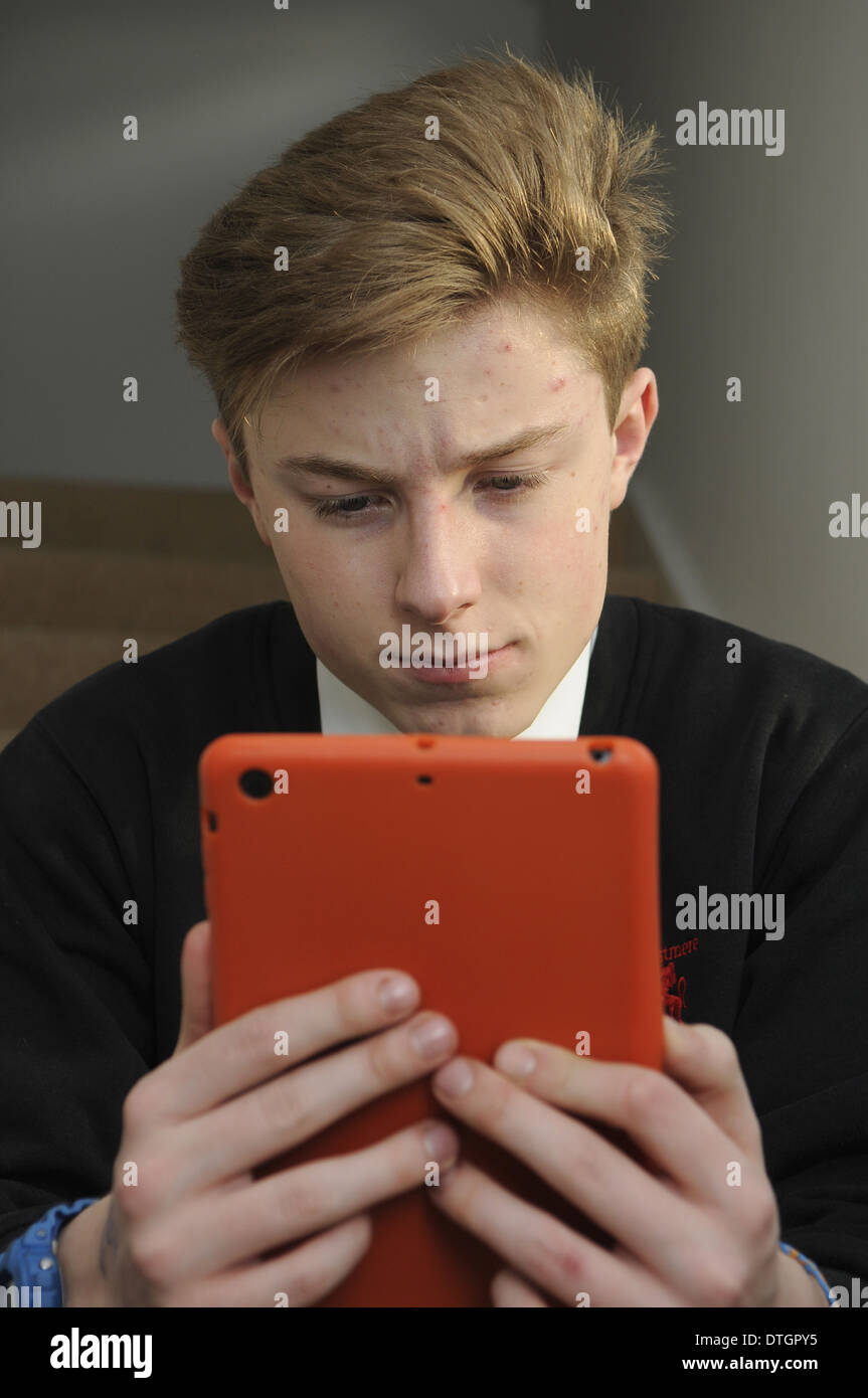 Teenage Boy Using A Tablet PC Stock Photo - Alamy
