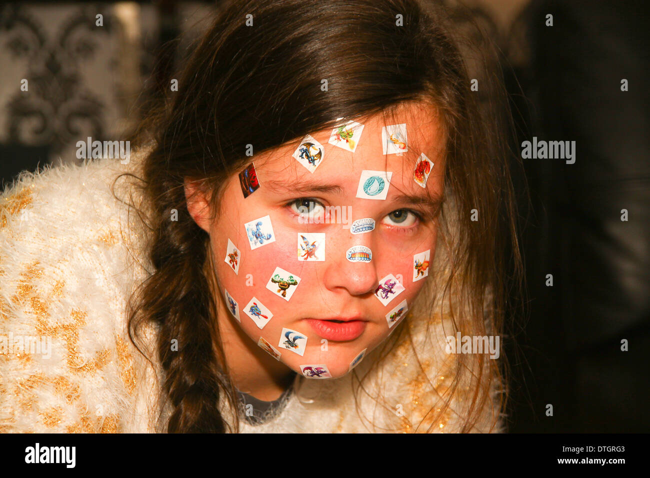 Yong girl with funny stickers on her face Stock Photo - Alamy