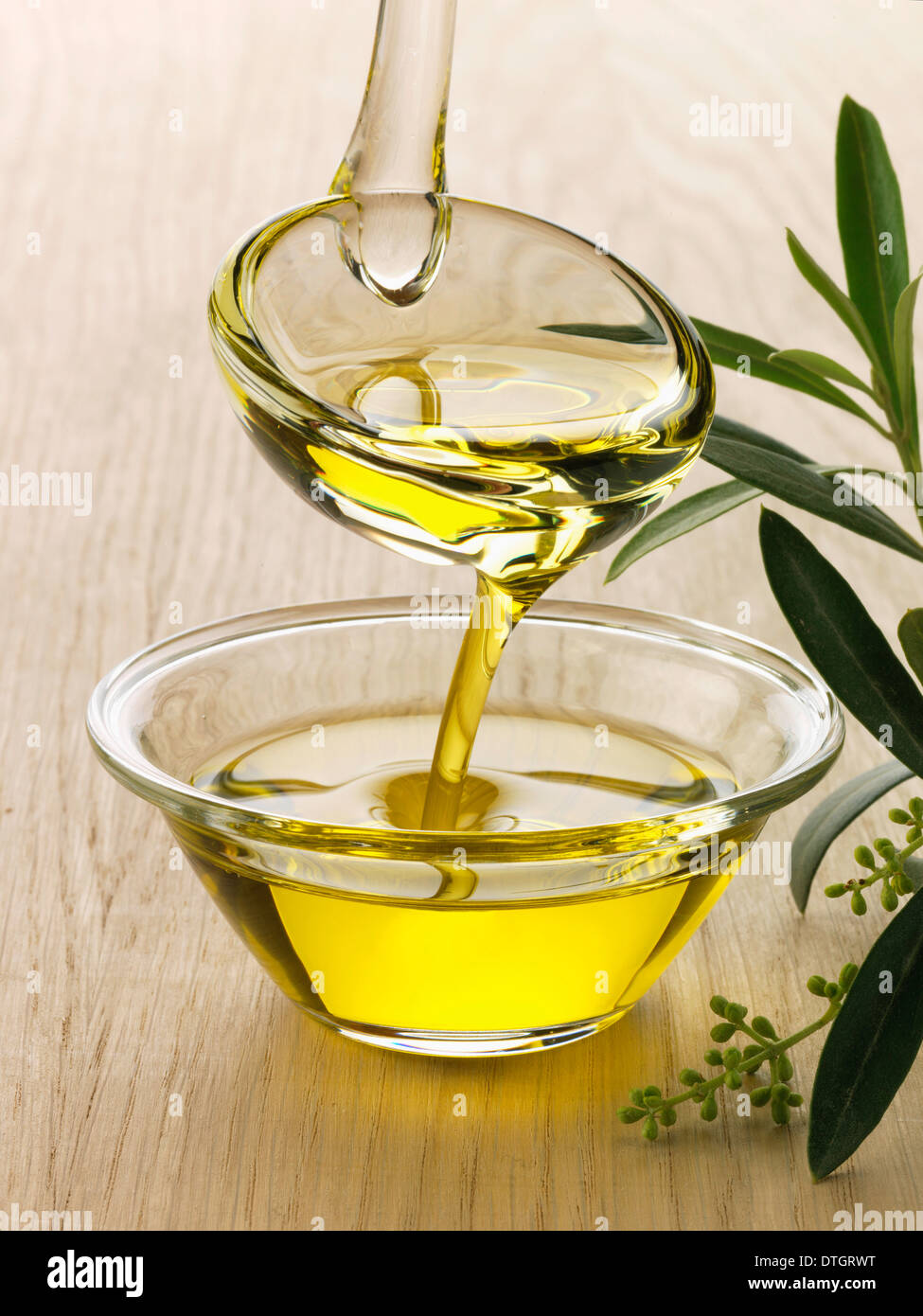 Bowl and ladle of oil Stock Photo - Alamy