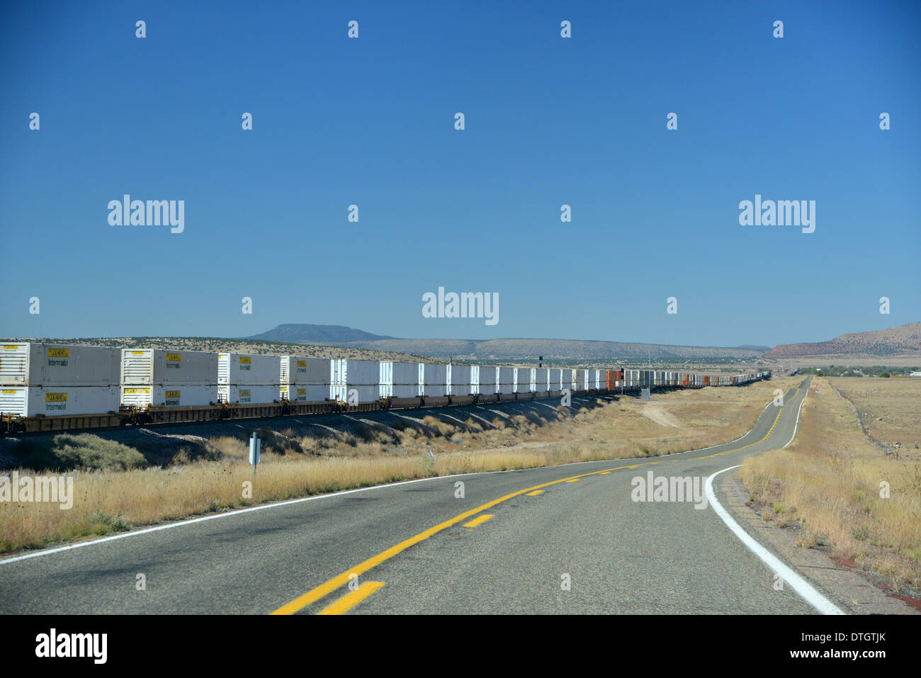 Route 66, Arizona, USA. Long road runs alongside a goods train on the ...