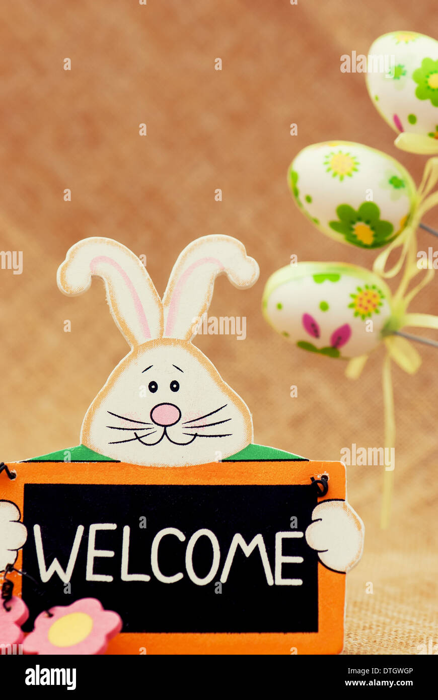 Easter smiling bunny with sign WELCOME and three painted eggs Stock ...